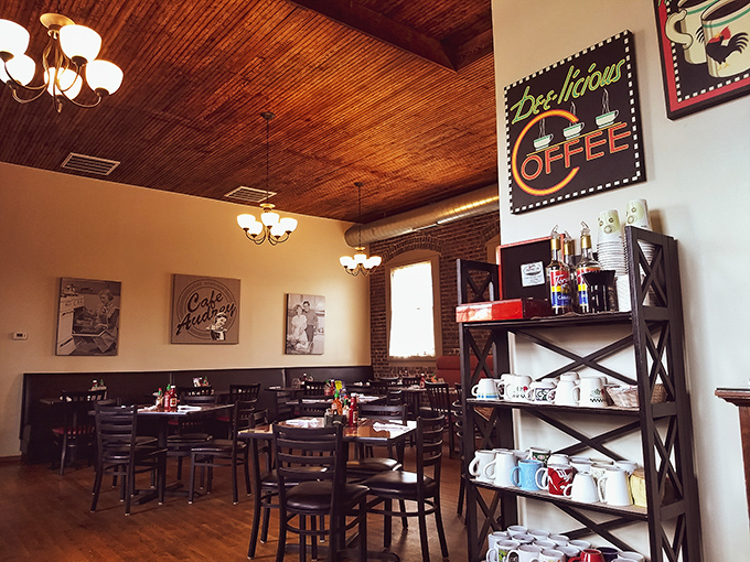 Wooden ceiling, warm lighting, and vintage coffee signs create the perfect backdrop for morning conversations and pancake consumption.