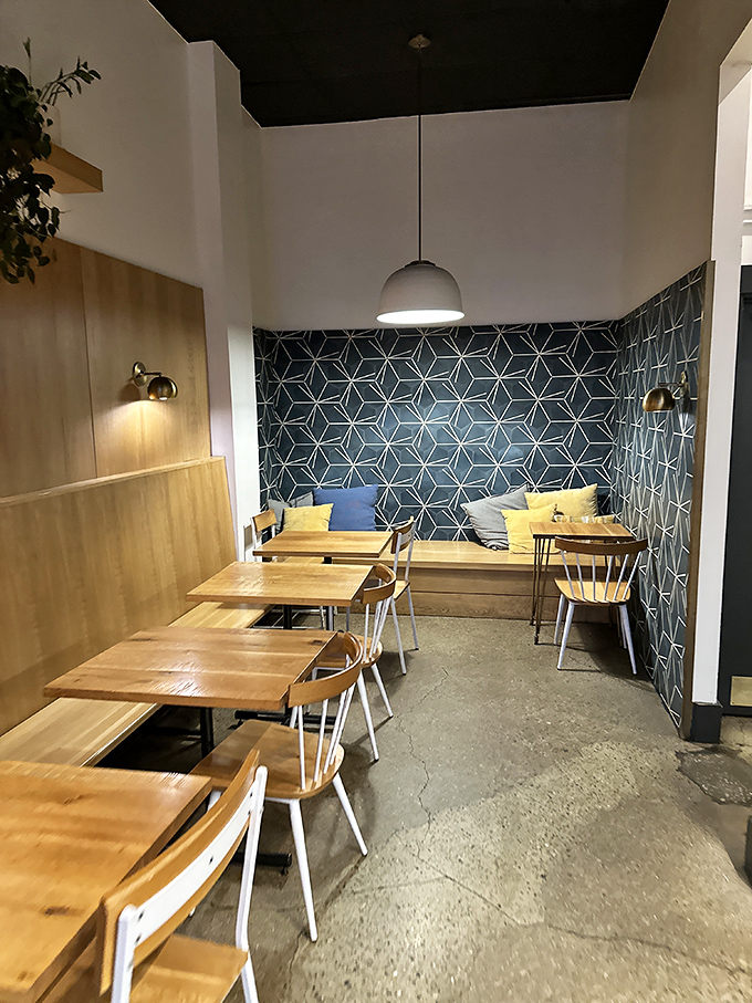 That geometric blue wall isn't just décor—it's a statement. "We take bagels seriously, but ourselves? Not so much."