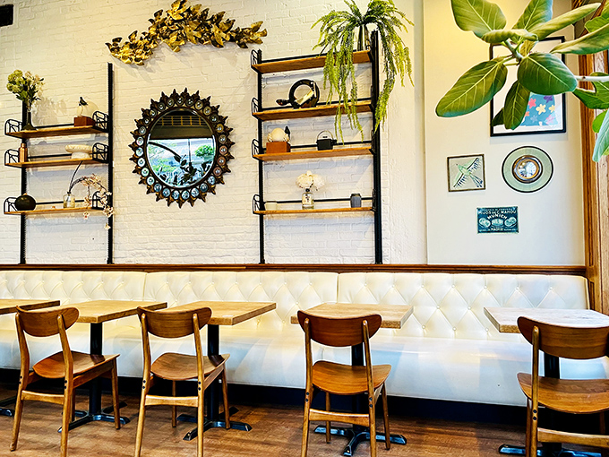 White walls, wooden accents, and thoughtful decor create the backdrop for countless conversations. Those plants aren't just decoration&mdash;they're witnesses to first dates and friendly reunions.