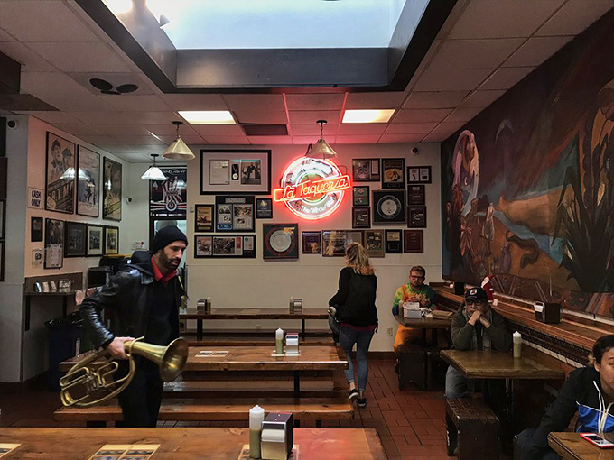 The neon glow bathes diners in a warm light as they commune over exceptional food. Walls of awards silently testify to decades of excellence.