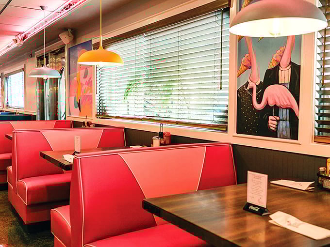 Cherry-red booths invite lingering conversations beneath playful pendant lights, while surreal flamingo art reminds you this isn't your average diner.