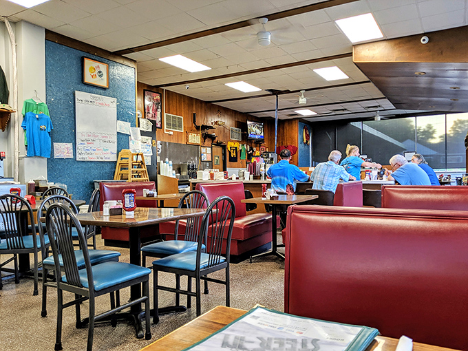 Red vinyl booths and wood-paneled walls create the perfect backdrop for conversations that flow as easily as the coffee refills.