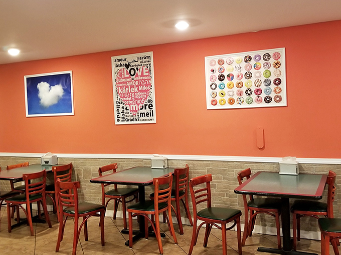 Coral walls and donut-themed art create the perfect backdrop for the internal debate: "One more donut or pizza?"