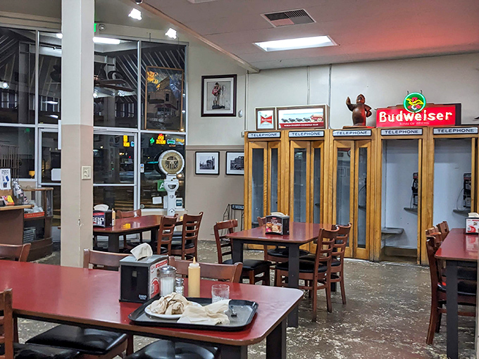 Red tables and sawdust floors create a timeless dining room where strangers become friends. 
