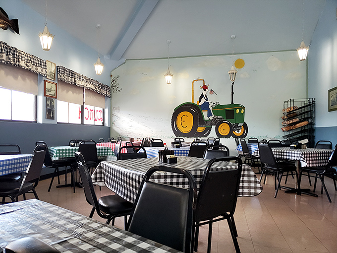 A tractor mural watches over diners like a guardian of agricultural heritage, while checkered tablecloths await the next hungry visitors.