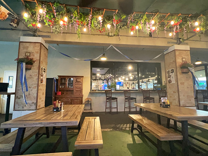 The biergarten's rustic wooden tables beneath twinkling lights create that magical atmosphere where strangers become friends and time slows to European pace.