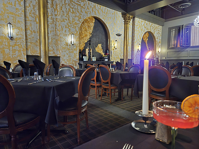 Gold-accented walls and candlelight create an atmosphere where even your credit card feels fancy. Dining rooms like this make Tuesday feel like Saturday.