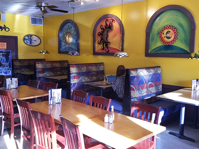 Stained glass-inspired artwork watches over diners like colorful guardians of good taste in this warmly lit dining room.