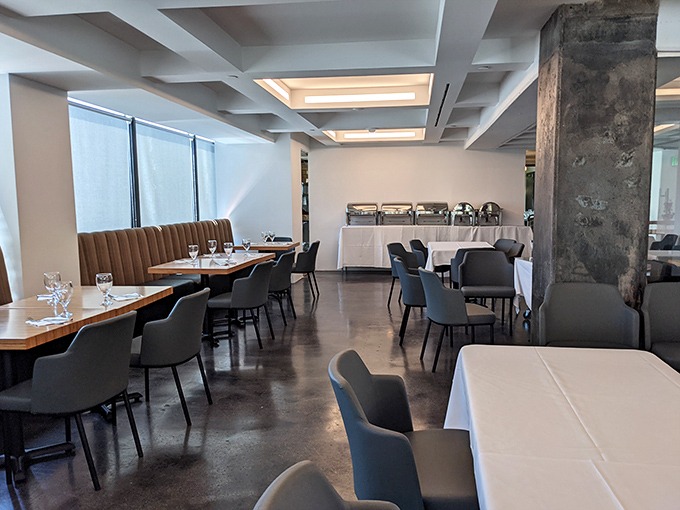 Modern meets traditional in this dining space where concrete floors and plush seating create the perfect backdrop for flavor adventures.