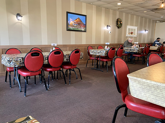 Red chairs and patterned tablecloths create a dining room that feels like Sunday dinner at a favorite relative's house. Minus the awkward family questions.