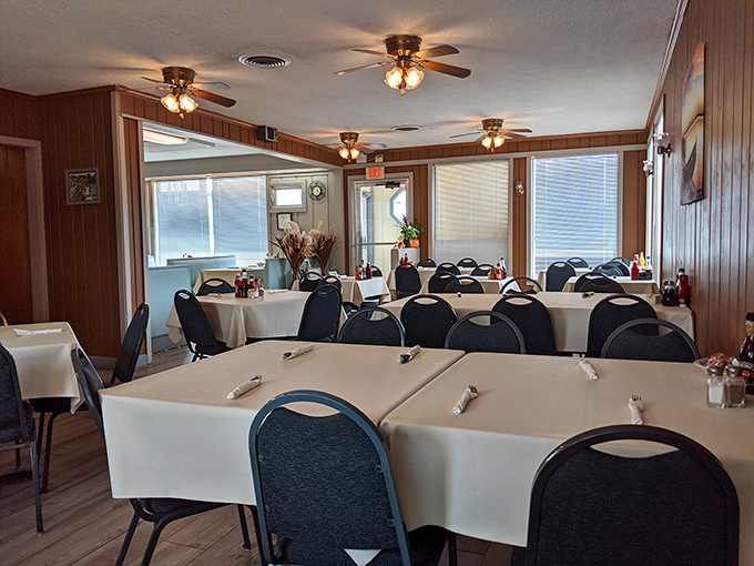 The dining area waits patiently for the breakfast rush, tables dressed in crisp white linens like they're ready for a morning party.