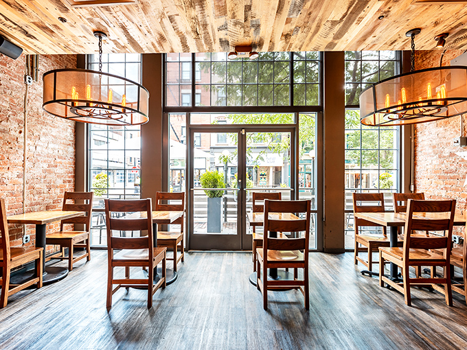 Wooden chairs, exposed brick, and those statement light fixtures create a dining space that feels both trendy and timeless.