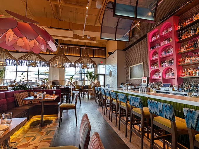 The dining area blends warm woods with vibrant colors and those signature flower lights. It's like being inside a stylish pi&ntilde;ata without the fear of being blindfolded.