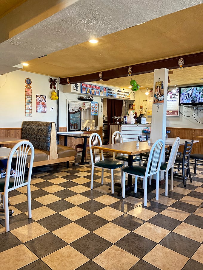The checkerboard floor might not be playing chess, but the dining area's simple charm makes you feel like you've just discovered your new favorite living room.