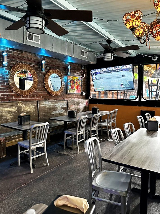 The dining area whispers "stay awhile" with its sunburst mirrors, exposed brick, and lighting that makes everyone look like they've just returned from vacation.