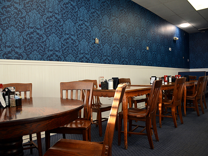 Blue damask wallpaper and wooden chairs create that perfect diner aesthetic&mdash;not too fancy, not too casual, just right for solving the world's problems over coffee.