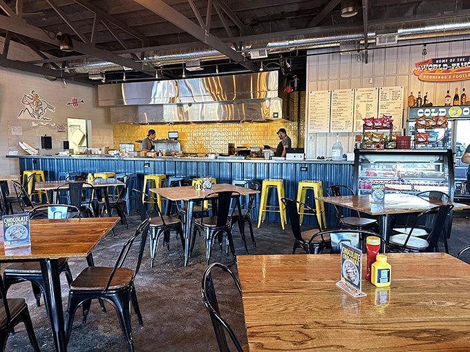 The dining area balances industrial elements with warmth&mdash;blue counter, wooden tables, and enough space to accommodate both quiet conversations and boisterous gatherings.