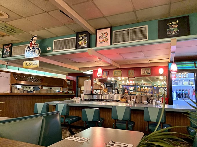 The counter seating area&mdash;where breakfast dreams come true and coffee cups never reach empty. Diners' paradise in turquoise and wood.