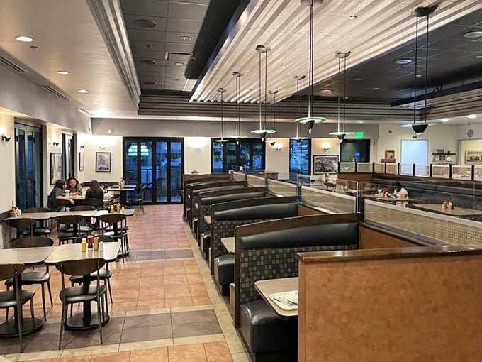 Comfort meets class in the dining area, where leather booths and thoughtful lighting create the perfect backdrop for serious sandwich consumption.