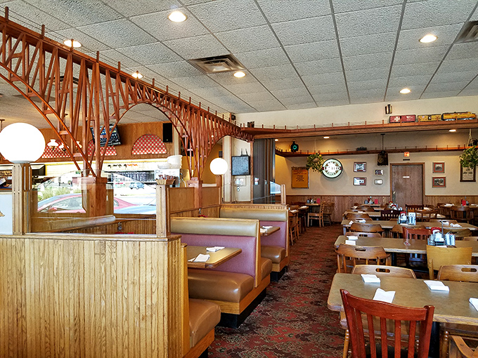 The wooden trestle bridge spanning the dining room isn't just decor&mdash;it's functional art, carrying miniature trains above conversations and comfort food below.