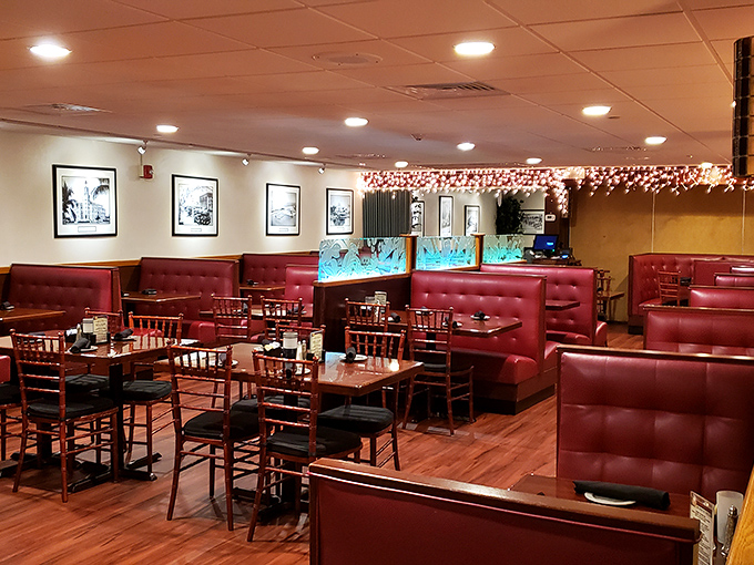 Red leather booths and warm lighting create that classic steakhouse ambiance where memories are made between bites of excellent beef.