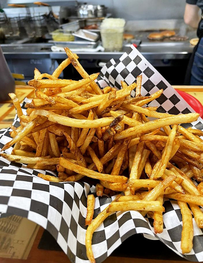 Fries so perfectly golden they deserve their own trophy. The checkered paper is just their victory lap.