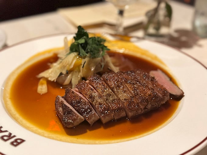 Duck breast, sliced with mathematical precision, lounging in its own magnificent jus&mdash;a dish that demands to be savored slowly.
