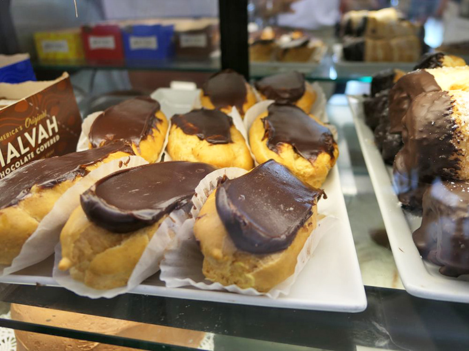 These chocolate-topped eclairs aren't just desserts; they're time machines to childhood joy&mdash;creamy, chocolatey perfection that makes diets wave white flags of surrender. Photo credit: <a href="https://www.yelp.com/user_details?userid=cI5puqZckvEnpFGpwDOcKQ" target="_blank" rel="noopener noreferrer">Lewis C.</a>