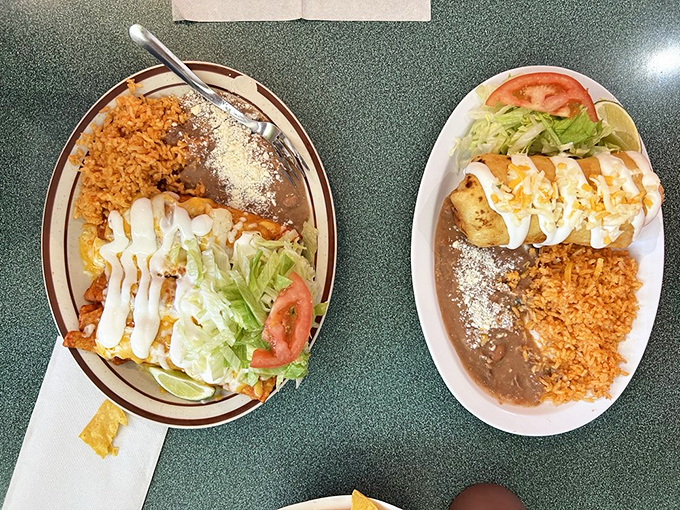 A study in contrasts: vibrant orange rice, velvety refried beans, and enchiladas swimming in sauce that's been perfected over countless family gatherings.