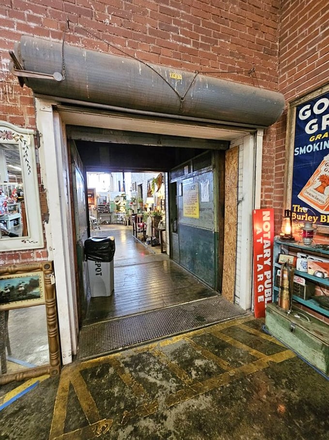 Explore this rustic industrial doorway to discover unique vintage signs and hidden treasures waiting for you inside this historic space.