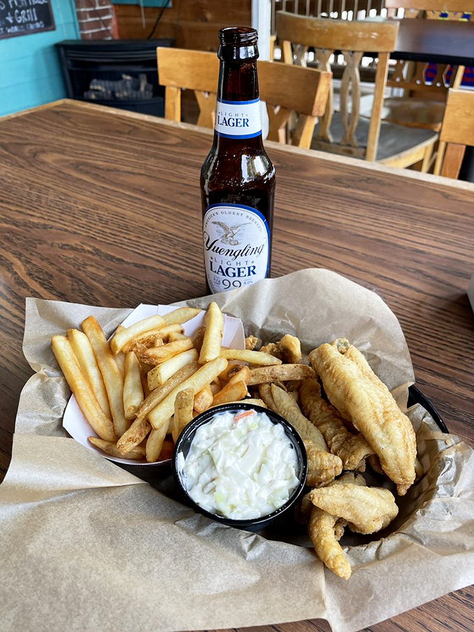 A cold Yuengling beside perfectly golden fish and chips&mdash;proof that sometimes the simplest pleasures are the most profound.