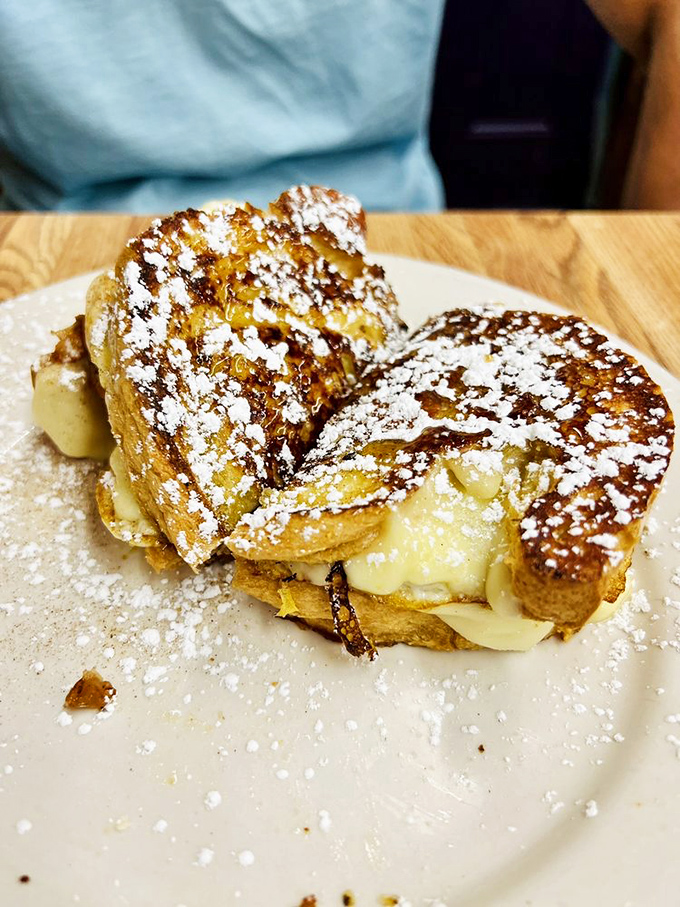 French toast that's having an identity crisis as dessert. Powdered sugar snowfall on golden bread mountains&mdash;breakfast has never looked so indulgent.