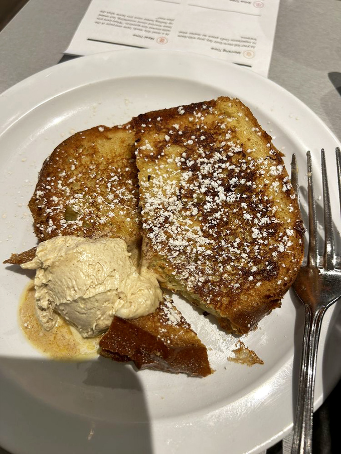 French toast that's been given the royal treatment, dusted with powdered sugar like a light Indiana snowfall.