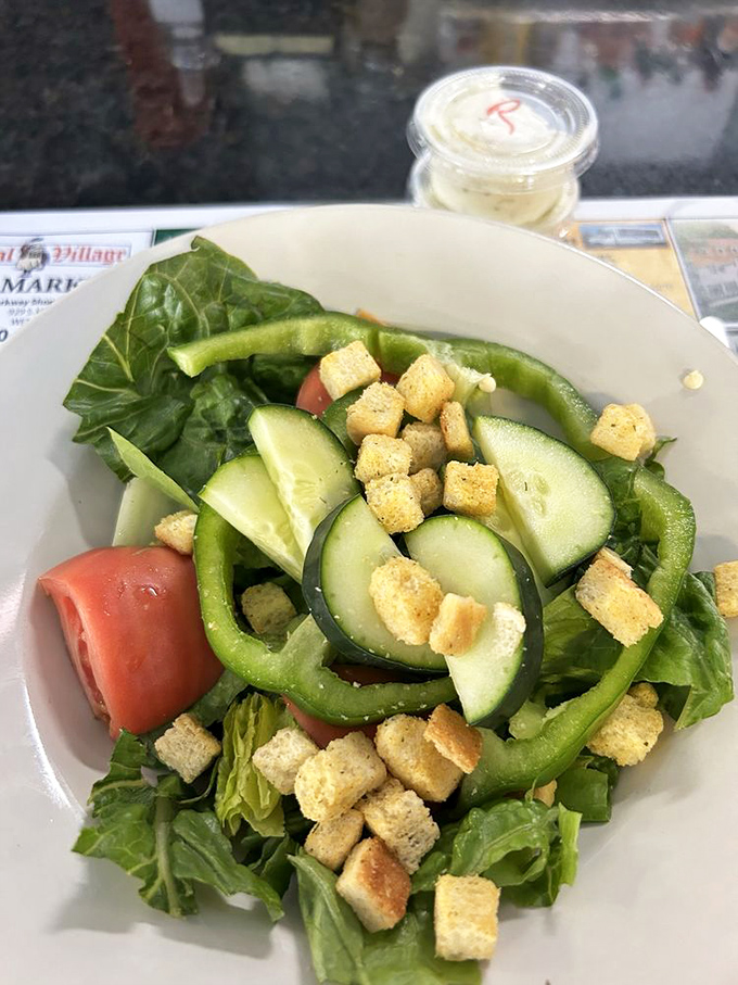 Even the salad looks like it's having a good time, with fresh veggies and croutons playing nicely together in a bowl of virtuous deliciousness.