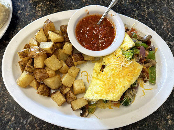 Garden omelets elsewhere feel like punishment; this one feels like vegetables finally found their breakfast soulmate.