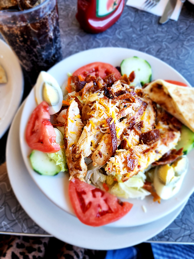 A grilled chicken salad that actually makes eating healthy look appealing&mdash;surrounded by fresh tomatoes and cucumbers like a protein-packed island paradise.