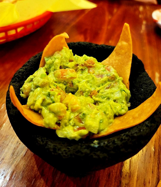This isn't the pale, lifeless guacamole from your supermarket. It's vibrant, chunky, and served in a traditional molcajete that weighs more than your phone bill.