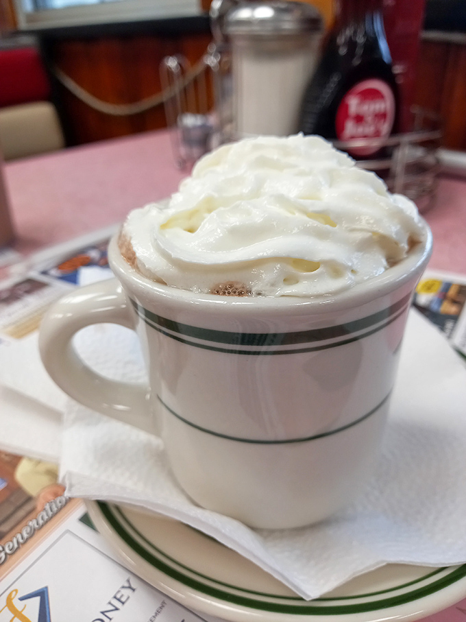 This isn't just hot chocolate, it's a warm hug in a mug. The whipped cream mountain on top is practically begging for a face-dive.
