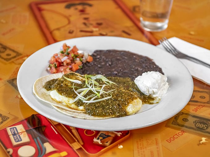 Huevos Rancheros that transport you straight to flavor country &ndash; where tortillas, beans, and perfectly cooked eggs unite under a blanket of vibrant salsa verde.
