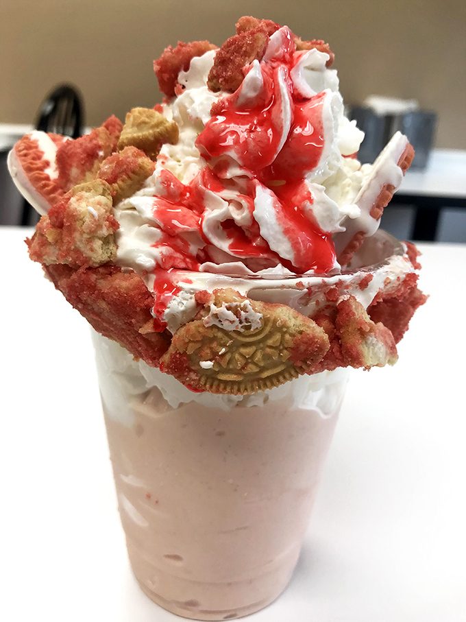 Some desserts whisper, but this one shouts! A strawberry shake crowned with whipped cream, cookies, and enough joy to power a small city.