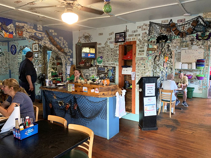 The dining area looks like it was decorated by a sea captain with excellent taste – fishing nets meet cozy comfort.