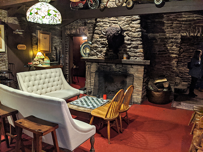 Stone fireplace, checkerboard table, and cozy seating&mdash;this isn't just a waiting area, it's a time machine to simpler, tastier times.