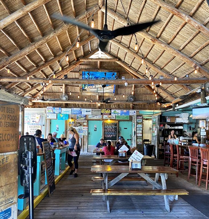 Sunlight streams through the open-air dining room where picnic tables invite you to linger longer than you planned.