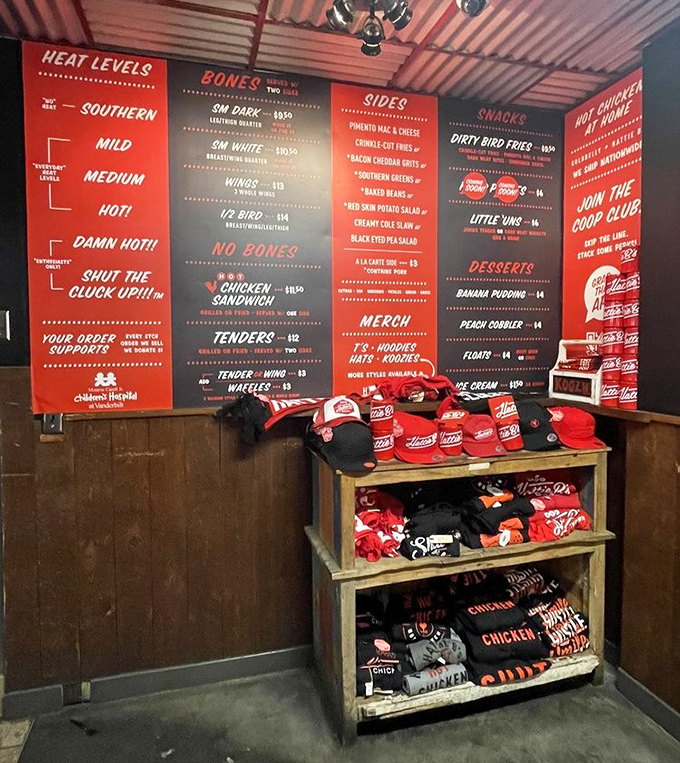 The merchandise wall showcases the cult following this chicken has inspired. Wear the logo like a badge of honor—you survived the heat.