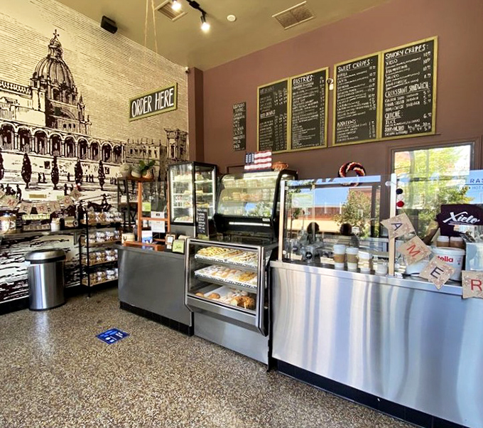 The interior feels like a European caf&eacute; that somehow landed in Oxnard, complete with architectural mural and display cases of temptation.