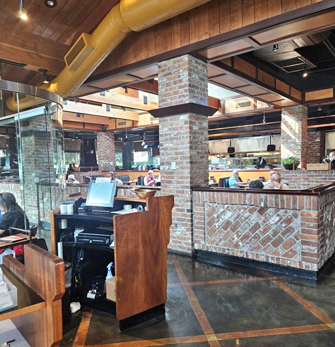 Exposed beams, brick columns, and the gentle hum of satisfied diners&mdash;a restaurant interior that feels like a warm Smoky Mountain hug.