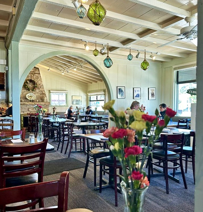 Colorful glass floats hang from white-beamed ceilings, creating the perfect maritime atmosphere for serious seafood consumption.