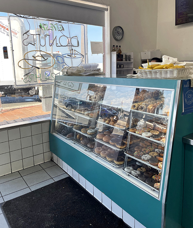 Donut display case standing like a jewelry counter, except these gems start around two dollars and bring significantly more joy.