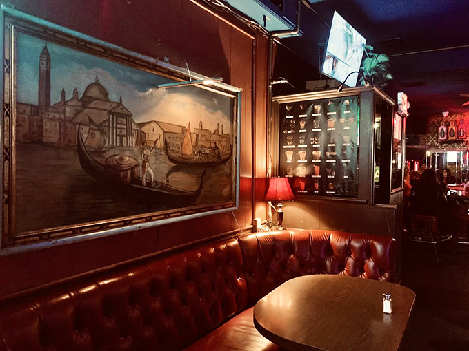 The Venetian-inspired artwork transports you to Italian canals while you sink into plush leather booths, creating an atmosphere that's part Old World, part old-school cool.