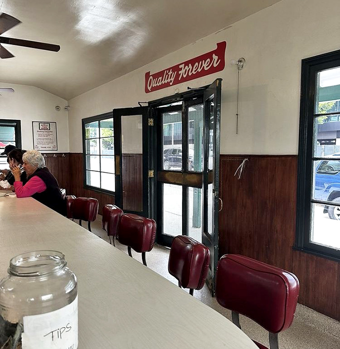 The "Quality Forever" sign watches over diners like a promise kept through decades of food trends that came and went while The Apple Pan stood its delicious ground.
